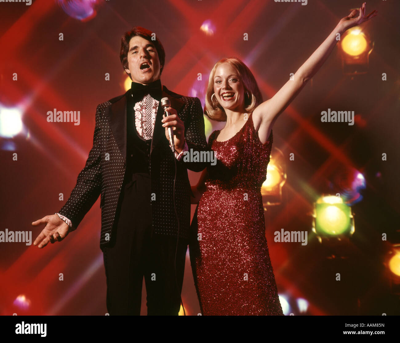 1970 1970s Duo Man Woman Couple Singing Woman Red Dress Gown Man Tuxedo