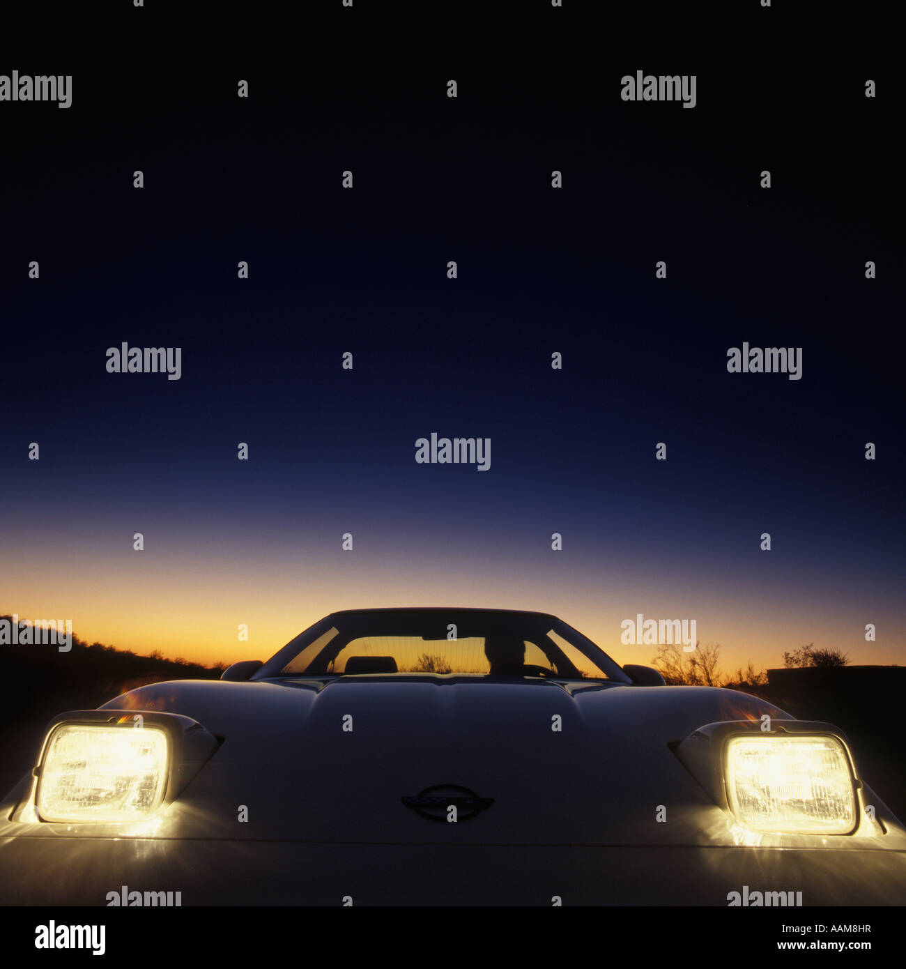 CORVETTE HOOD AND HEADLIGHTS EVENING DUSK DRIVING Stock Photo - Alamy