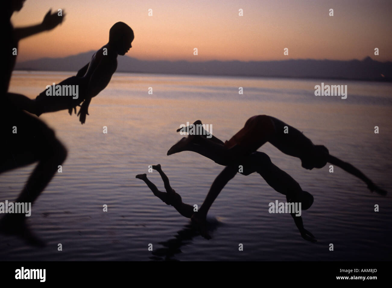 Kids jumping off a pier into the ocean Rio de Janeiro Brazil Stock ...