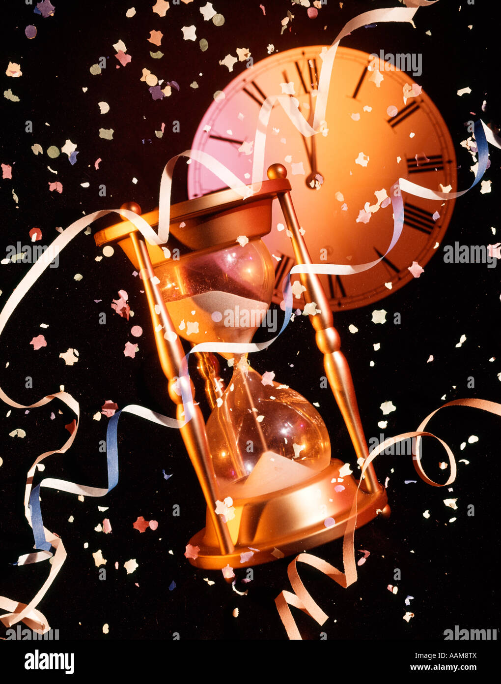 NEW YEARS STILL LIFE HOURGLASS CLOCK AND CONFETTI Stock Photo - Alamy