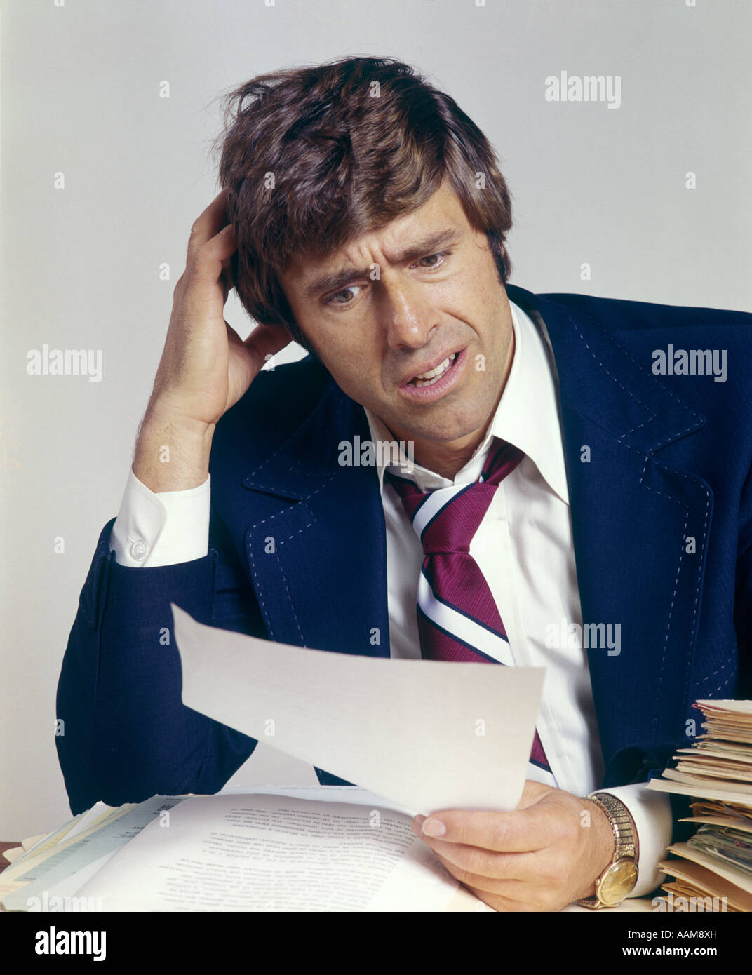 MAN OFFICE BUSINESS WORKING WORK PAPERWORK CONFUSED CONFUSION TROUBLED ...