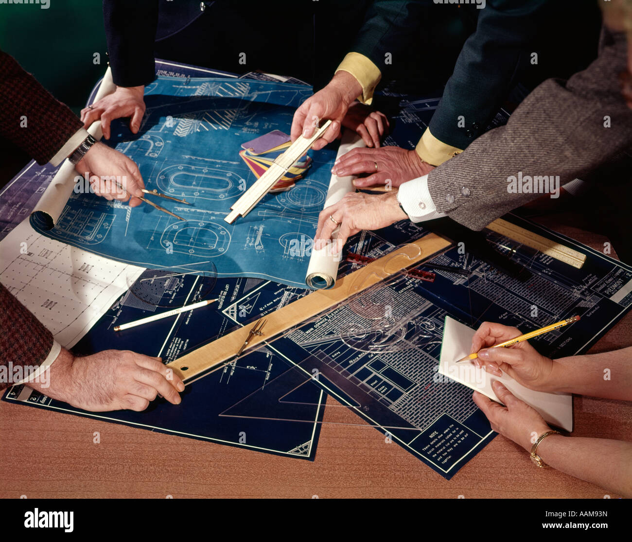 1960s GROUP 4 PAIR MALE HANDS OVER TABLE COVERED WITH PAPERS BLUEPRINTS ...