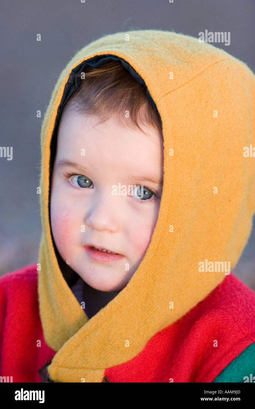 Little girl in multi coloured coat Stock Photo - Alamy