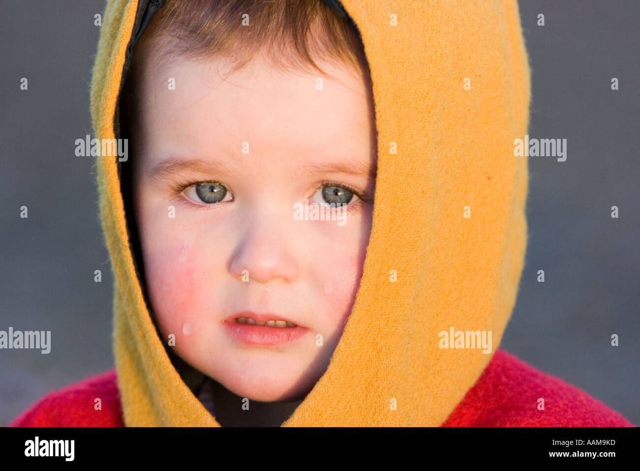 Little girl in multi coloured coat Stock Photo - Alamy