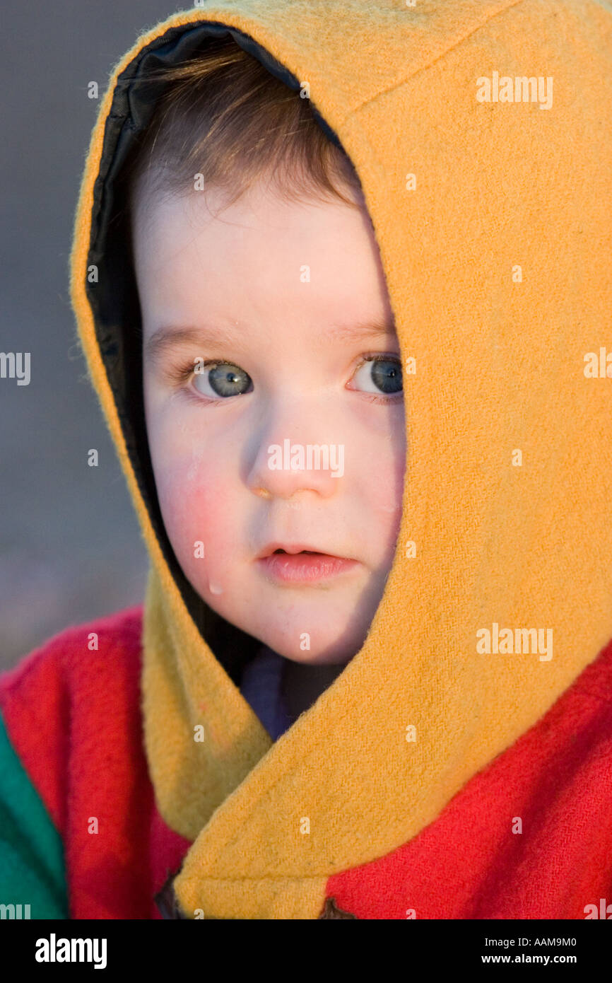 Little girl in multi coloured coat Stock Photo - Alamy