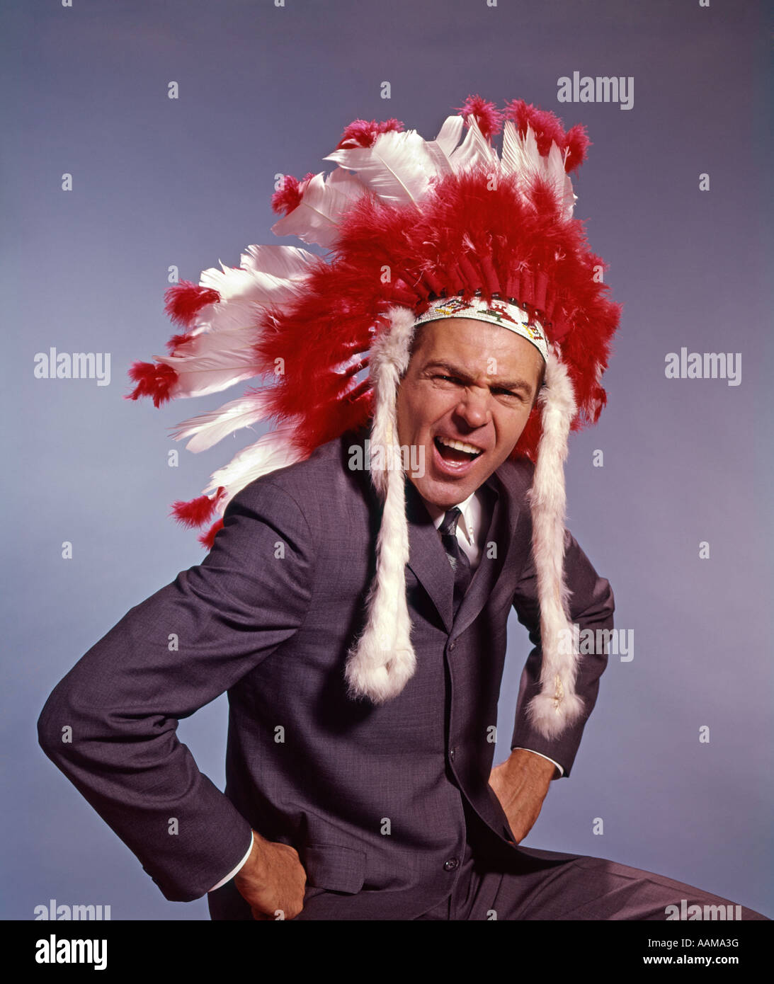 1970s MAN IN NATIVE AMERICAN COSTUME HEADDRESS AND SUIT WITH HANDS ON ...
