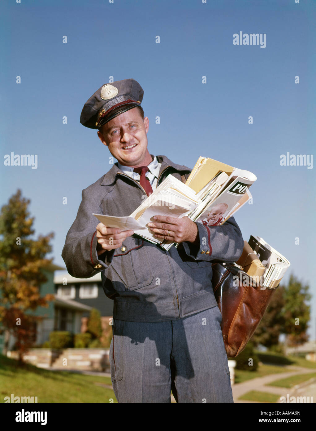 1960s SMILING MAILMAN HODLING LETTERS MAIL MAILBAG Stock Photo - Alamy