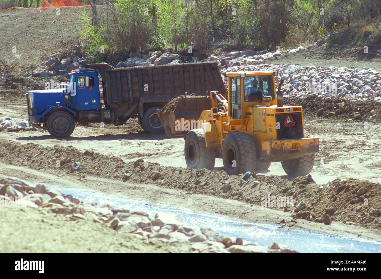 Wheel loader and dump truck Stock Photo - Alamy