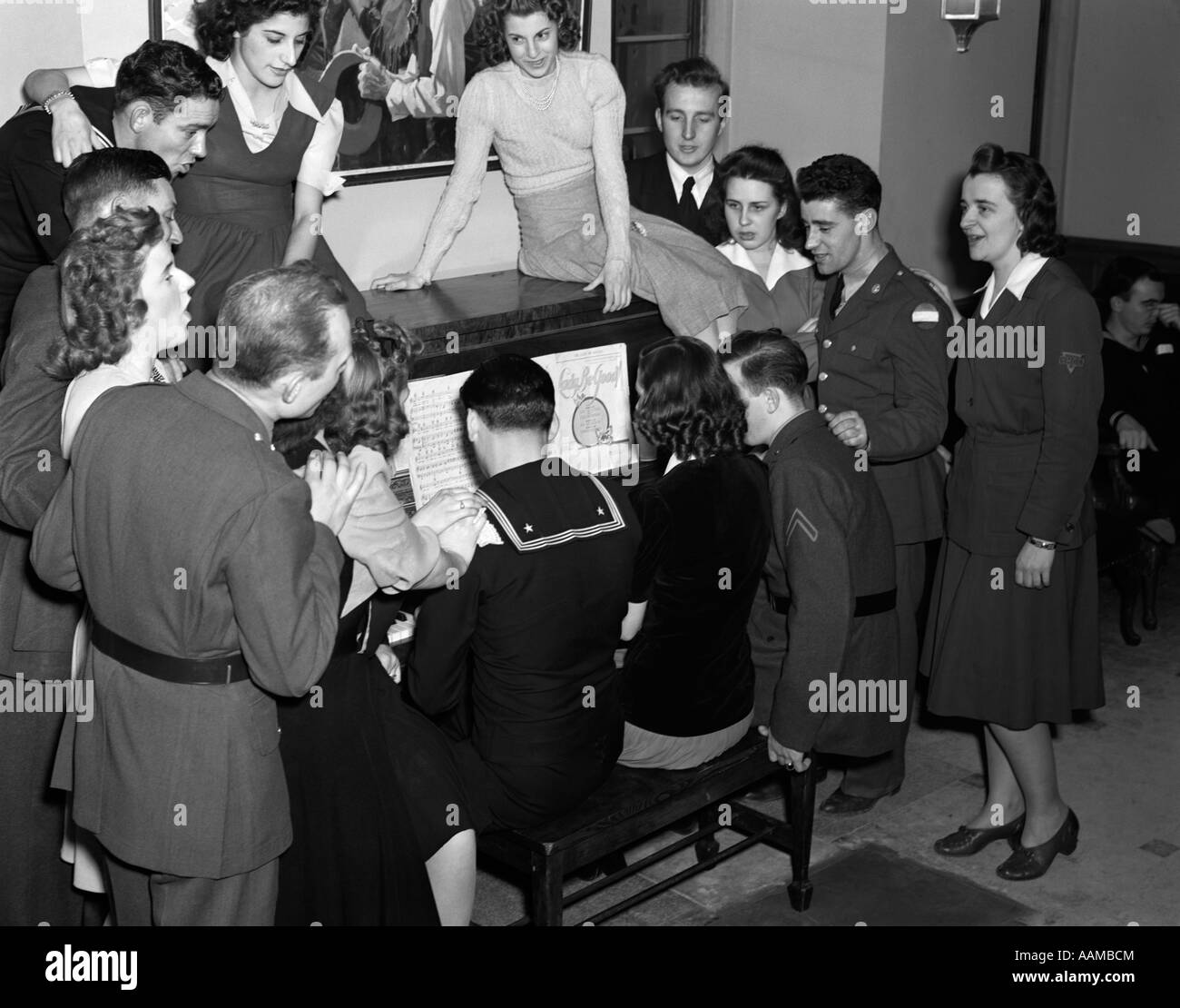 1940s GROUP OF SOLDIERS SAILORS AND WOMEN IN A VOLUNTEER USO CANTEEN ...