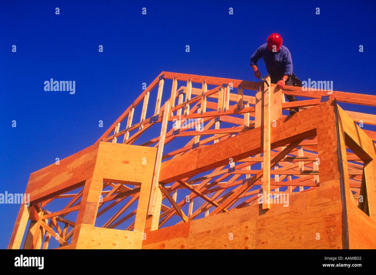 Construction worker working on wood frame home under construction NW ...