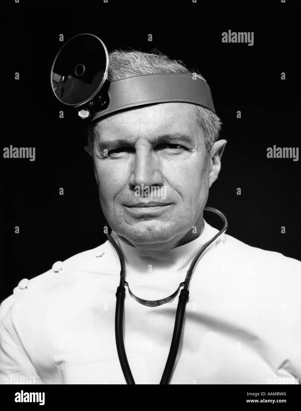 1940s PORTRAIT OF SENIOR DOCTOR WEARING OPTHALMOSCOPE AND STETHOSCOPE ...