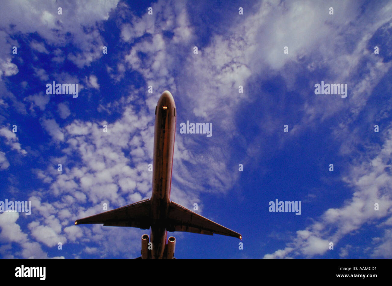Looking up at aiplane flying with blue sky and clouds Stock Photo - Alamy