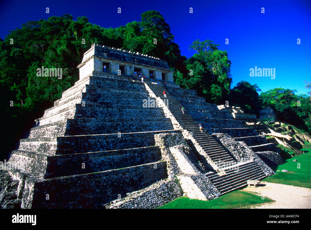 Tourists climbing up and down on the stone steps of the Mayan Temple of ...