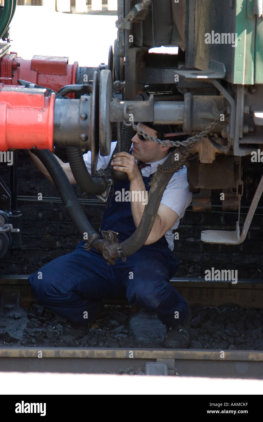 Coupling up the linkage between the steam locomotive and carriages on a ...