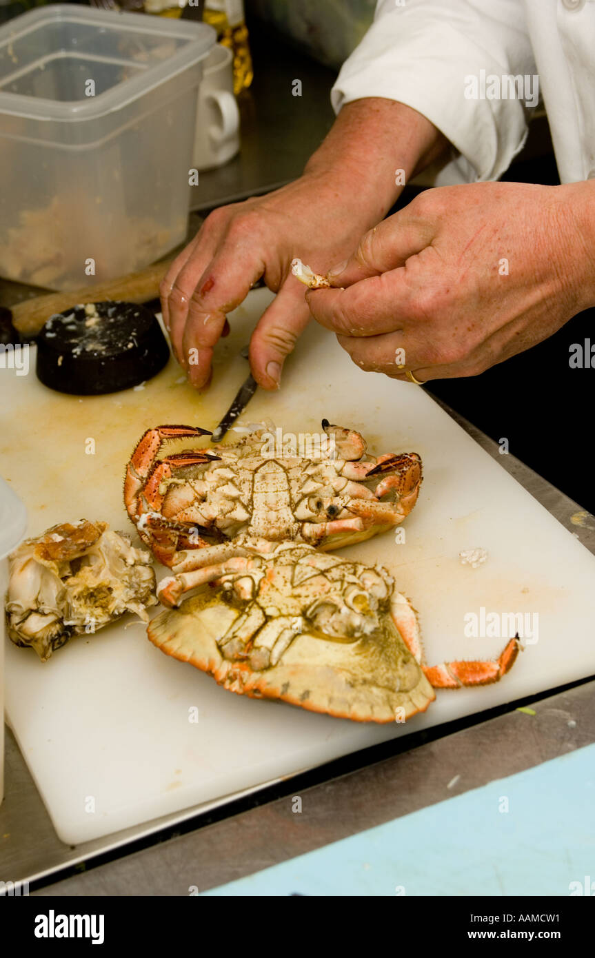 A man preparing Fresh local crabs at The Shed seafood restaurant ...