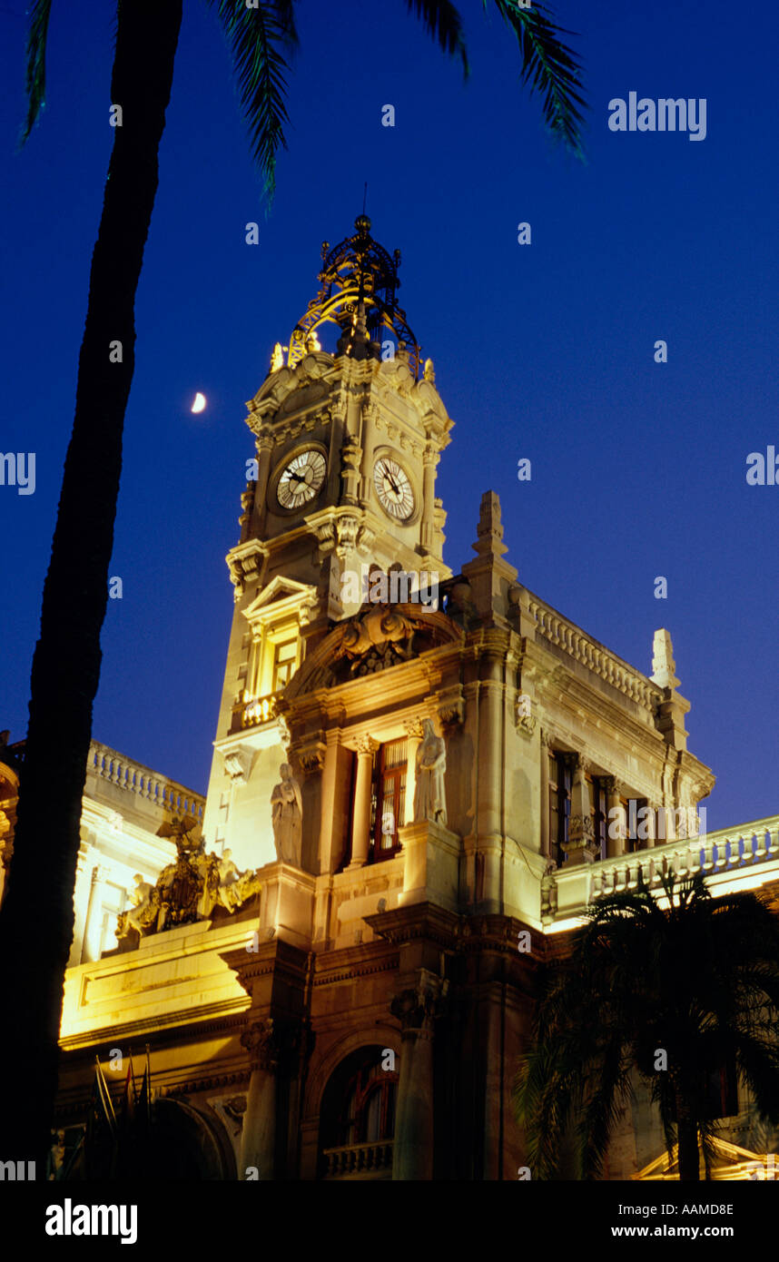 The Moon rises in the sky behind the illuminated clock tower atop City ...