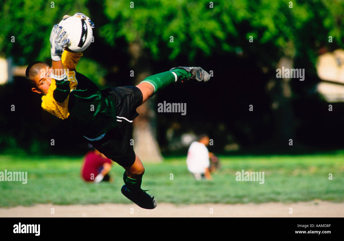soccer goalee diving to make a goal save football Stock Photo - Alamy