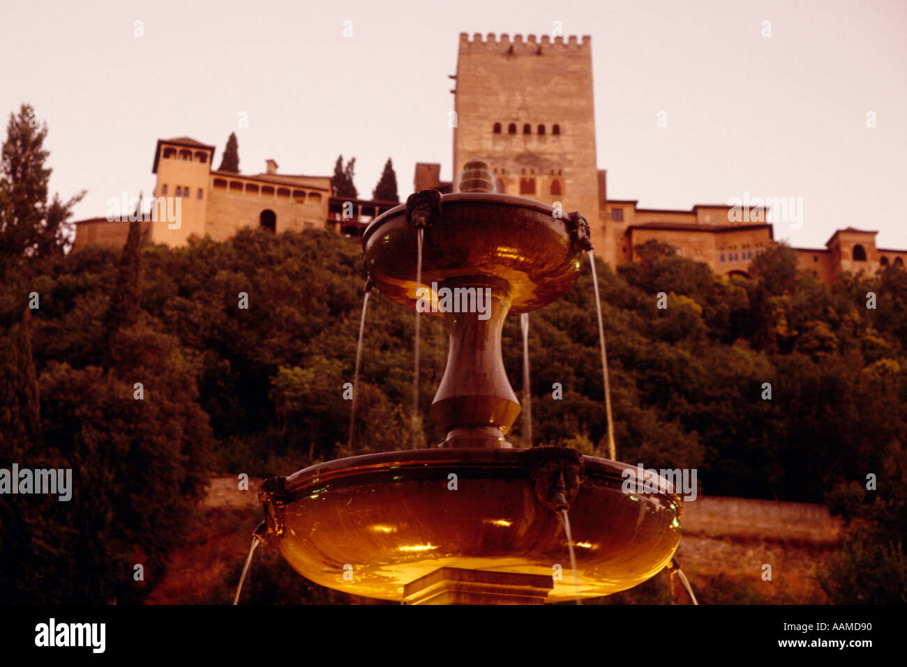 A fountain spews water below The Alhambra in Granada Spain Stock Photo ...