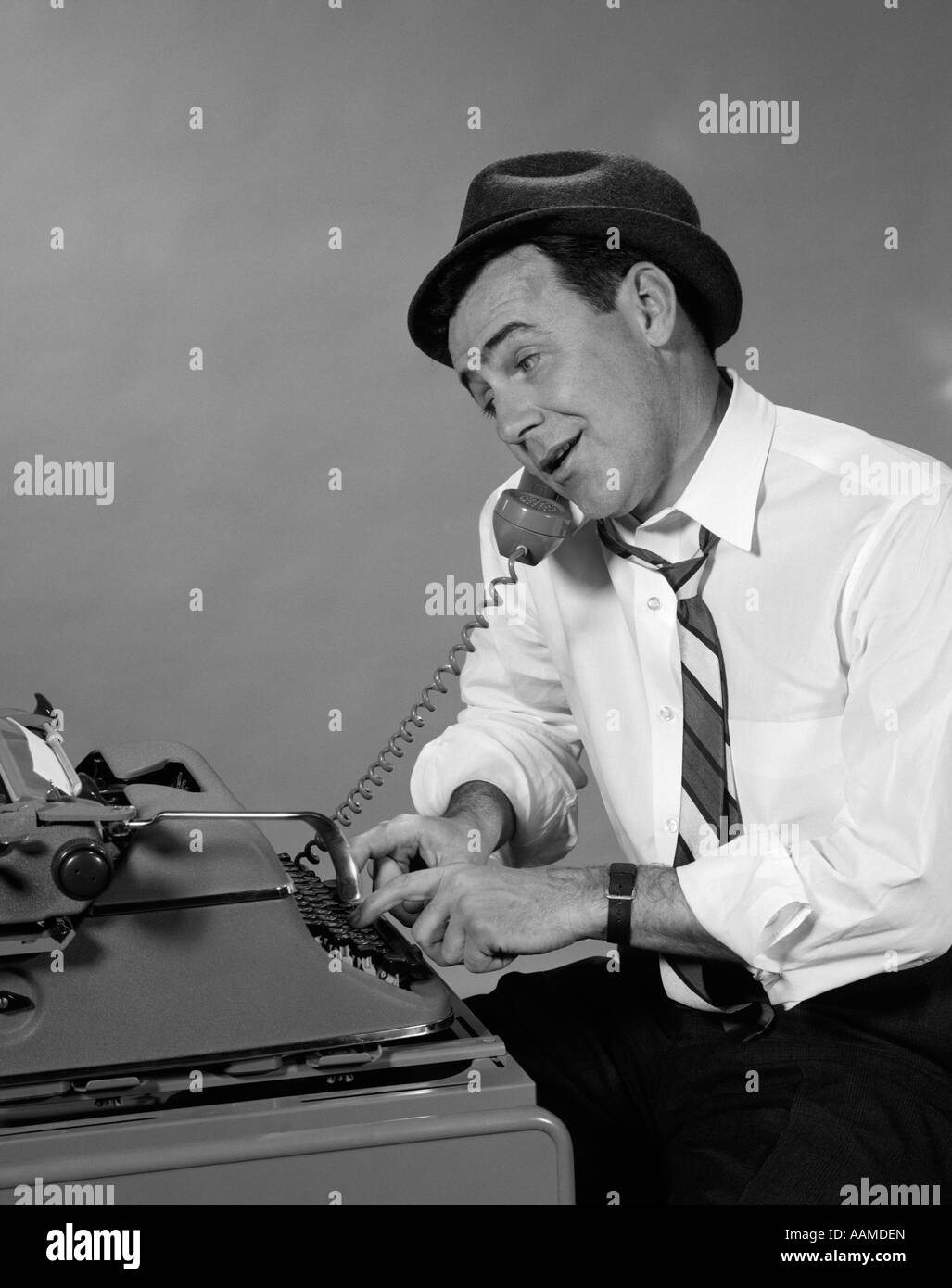 1960s REPORTER WITH HAT ON PHONE AT TYPEWRITER Stock Photo - Alamy