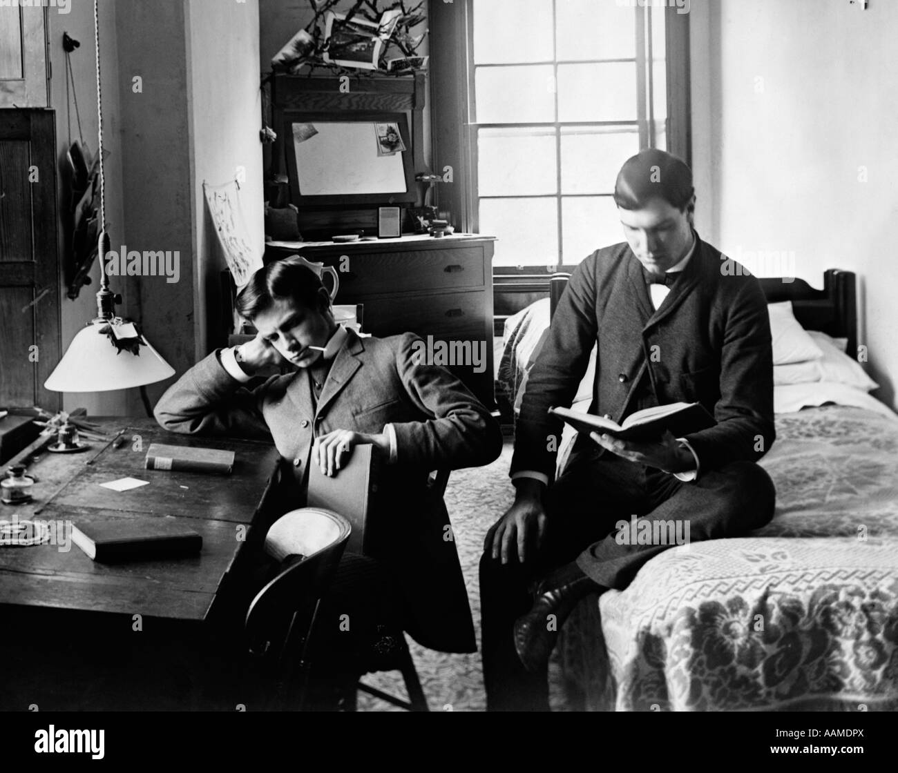 1890s 1894 PAIR OF MALE STUDENTS STUDYING IN DORM ROOM Stock Photo - Alamy