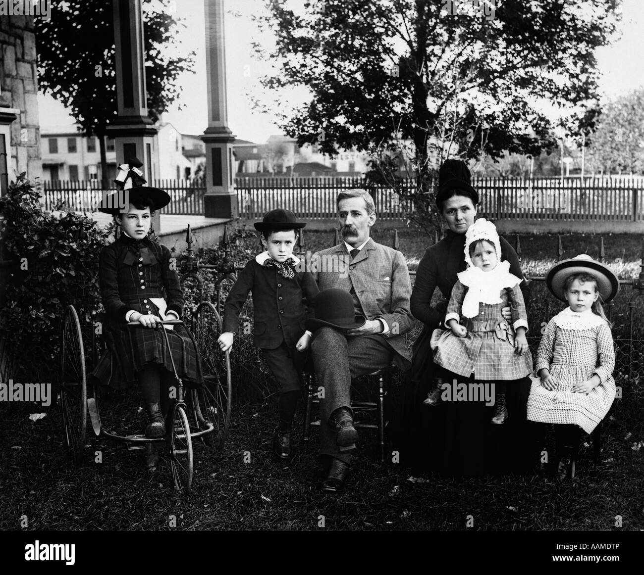 1900s TURN OF THE CENTURY FAMILY OF SIX SITTING IN FRONT YARD WITH ONE ...