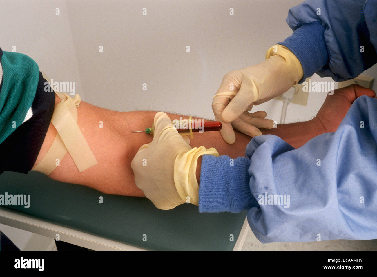 Medical technician draws blood from man in doctor s office Stock Photo ...