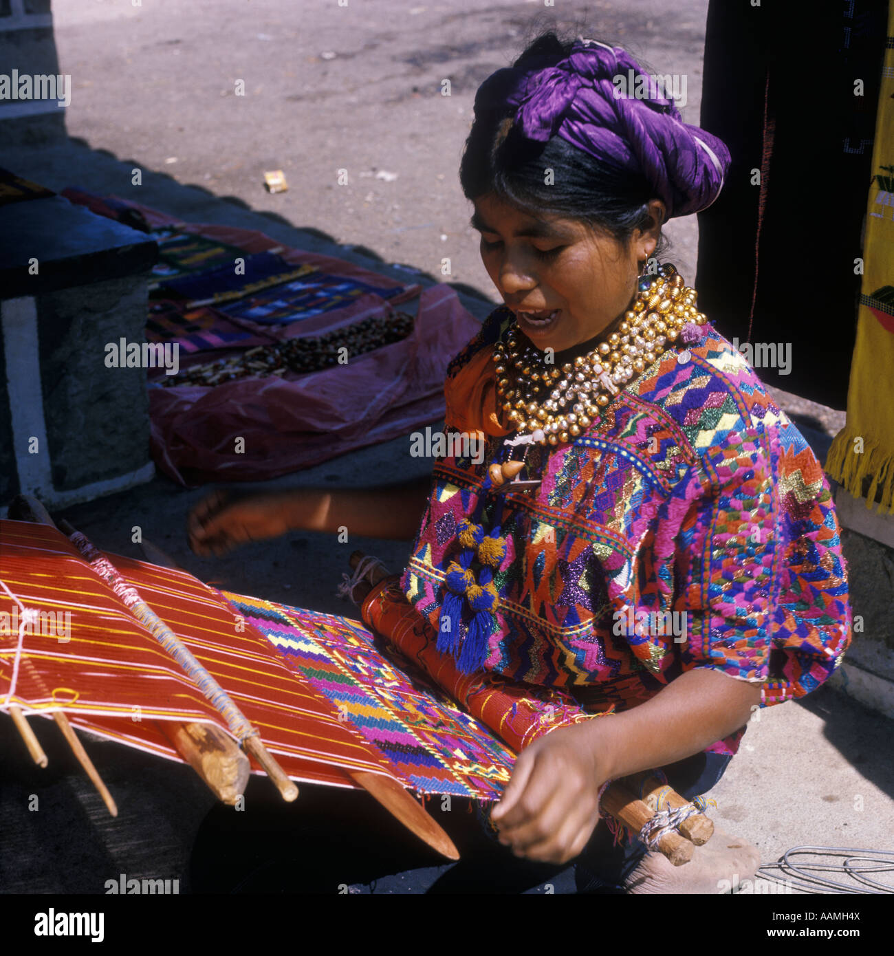 QUICHE INDIAN WOMAN WEAVING ON BACKSTRAP LOOM WITH COLORFUL YARNS ...