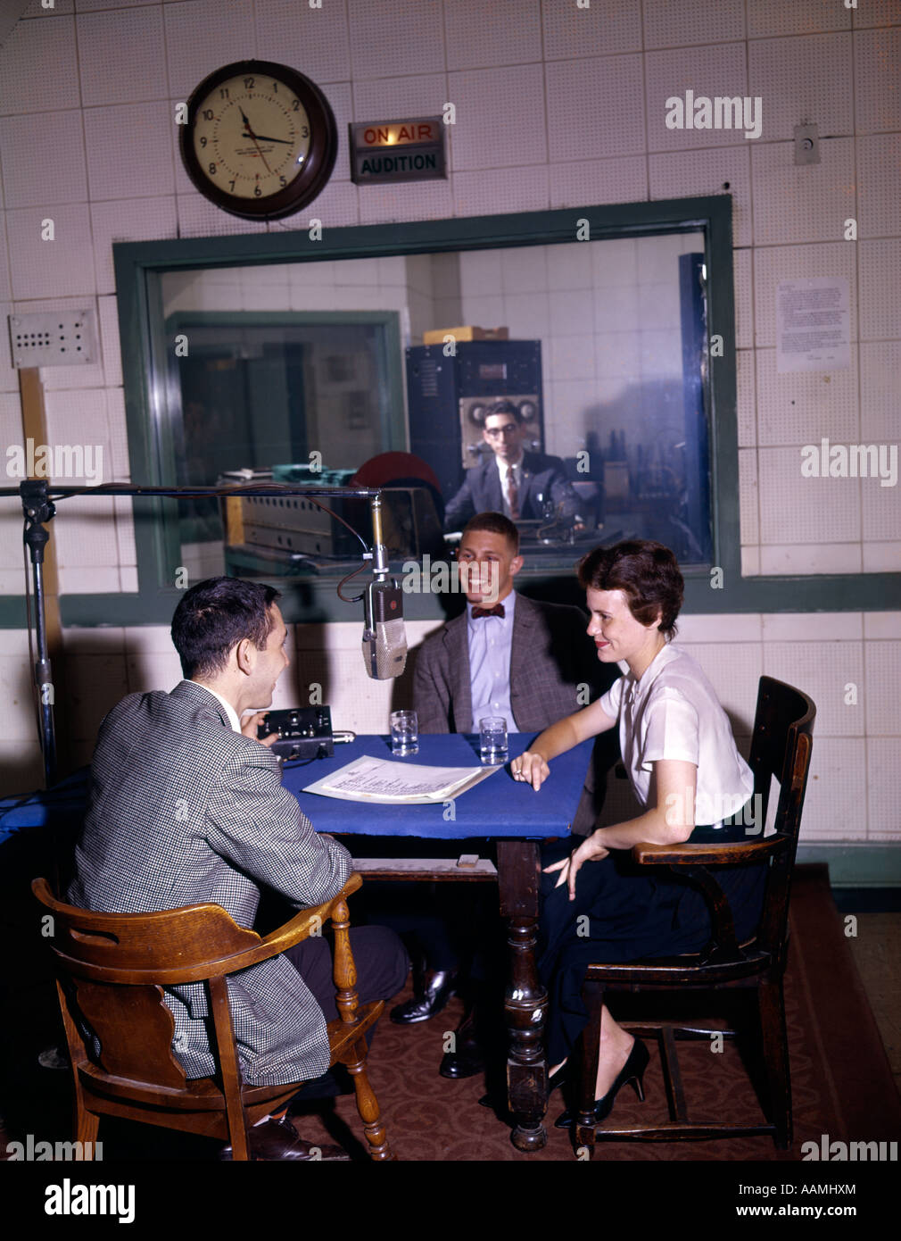 1960s COLLEGE RADIO STATION DJ INTERVIEW MAN & WOMAN AROUND MICROPHONE ...