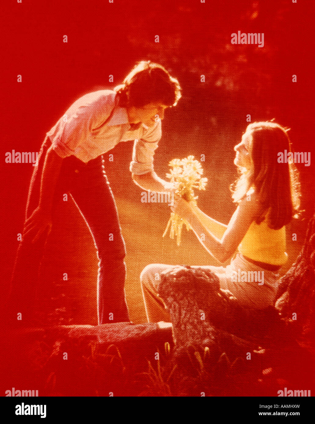 1970 1970s ROMANTIC COUPLE MAN GIVING WOMAN FLOWER BOUQUET RED LINEN ...
