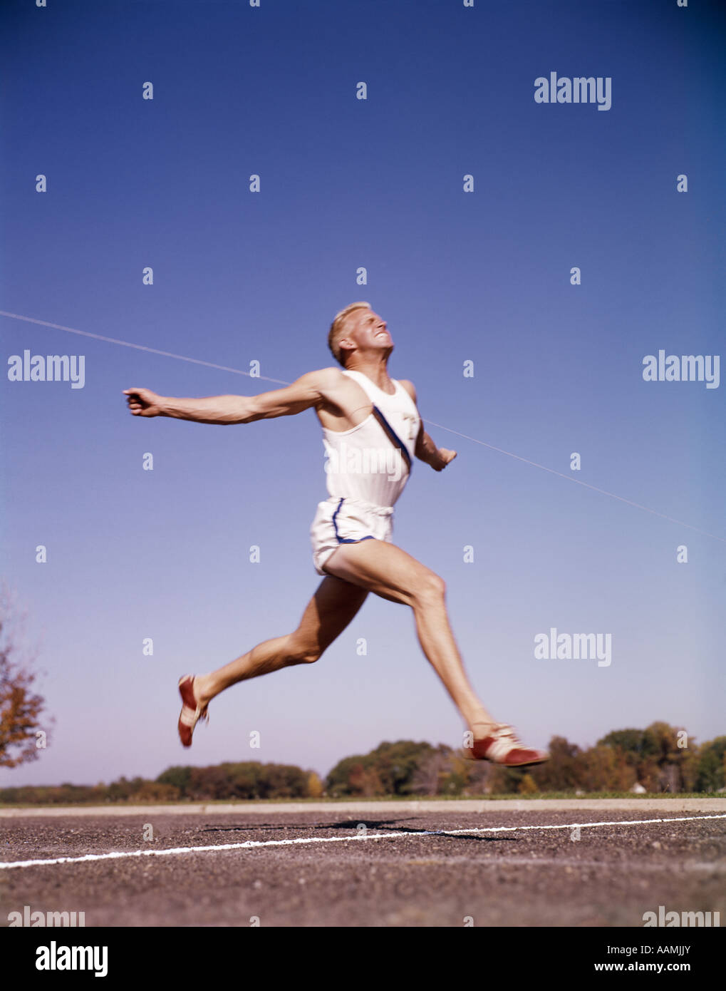Runner breaking through finish line hi-res stock photography and images ...
