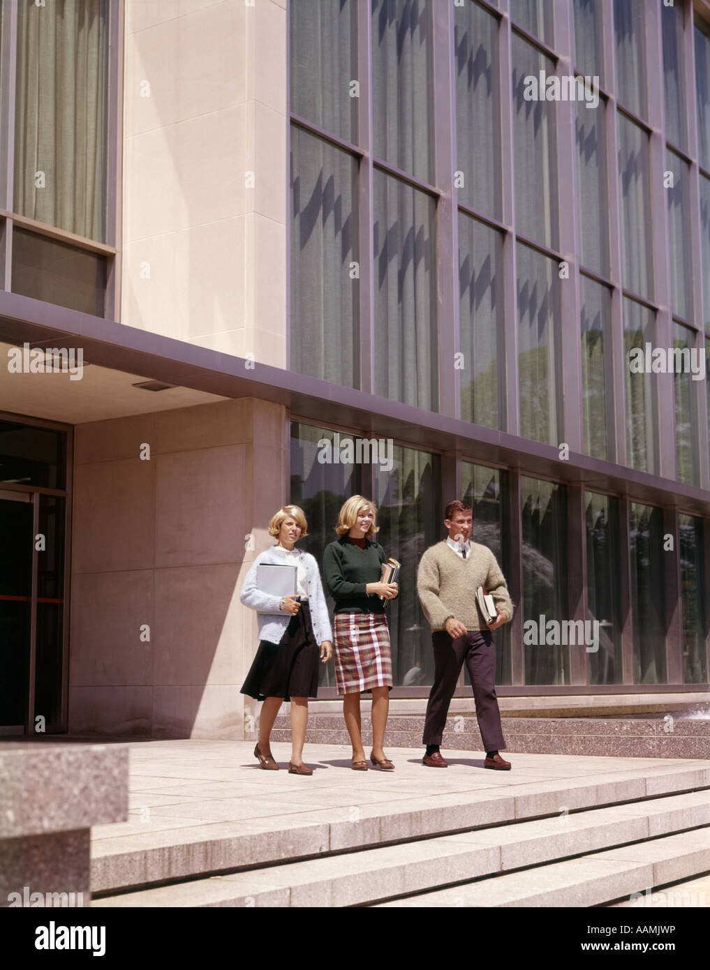 1960s 3 TEEN STUDENTS ON STEPS CARRYING BOOKS CAMPUS HIGH SCHOOL ...