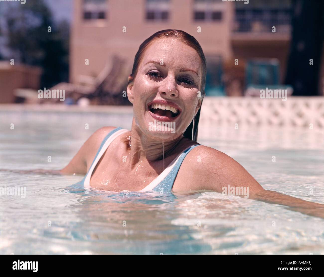 WOMAN LAUGHING IN SWIMMING POOL Stock Photo - Alamy