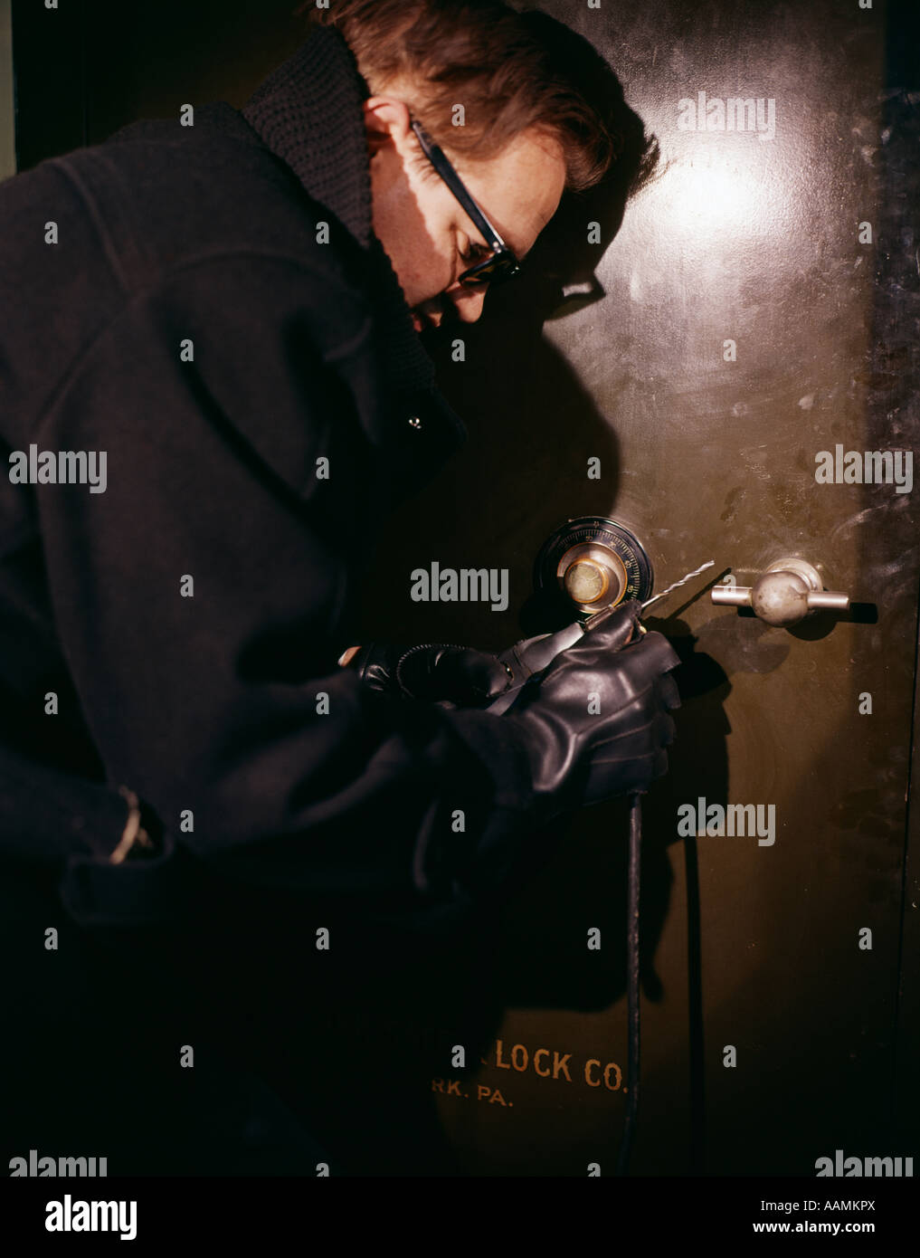 1960s MAN BLACK COAT GLOVES CRIMINAL HOLDING DRILL ABOUT TO BREAK OPEN ...