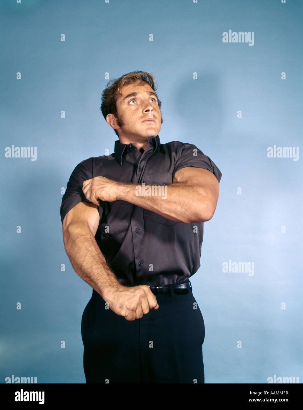 Man rolling up sleeve hi-res stock photography and images - Alamy