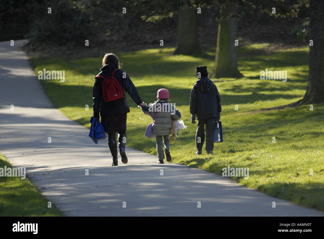 A family walk to school in the morning Stock Photo - Alamy