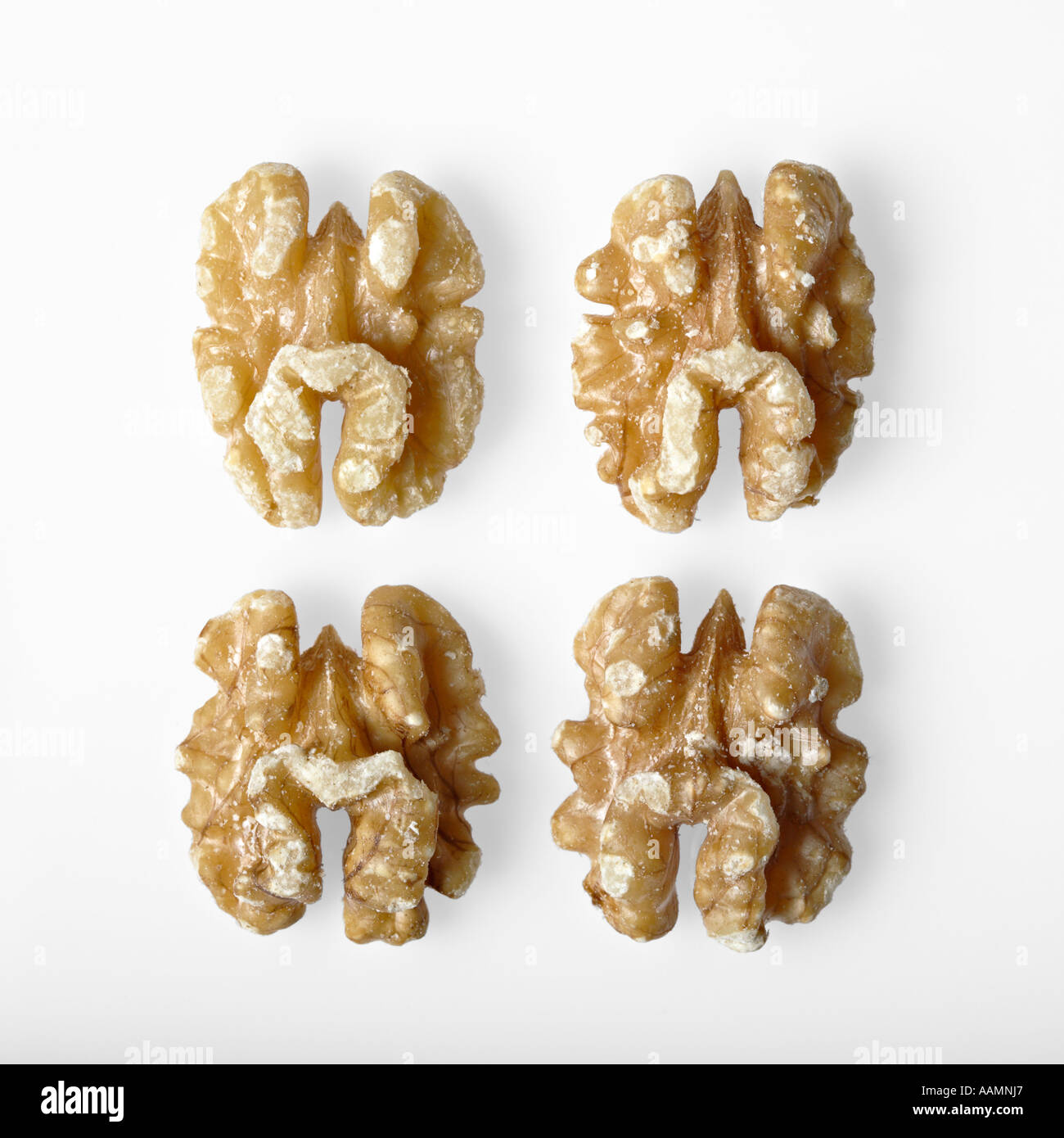 Walnut halves on white background Stock Photo - Alamy