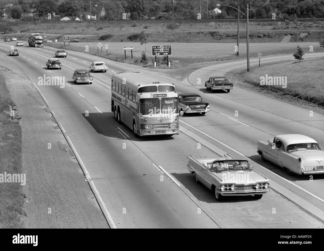 1960s PARTIAL OVERHEAD OF BUSY HIGHWAY WITH CONVERTIBLE & CHARTER BUS ...