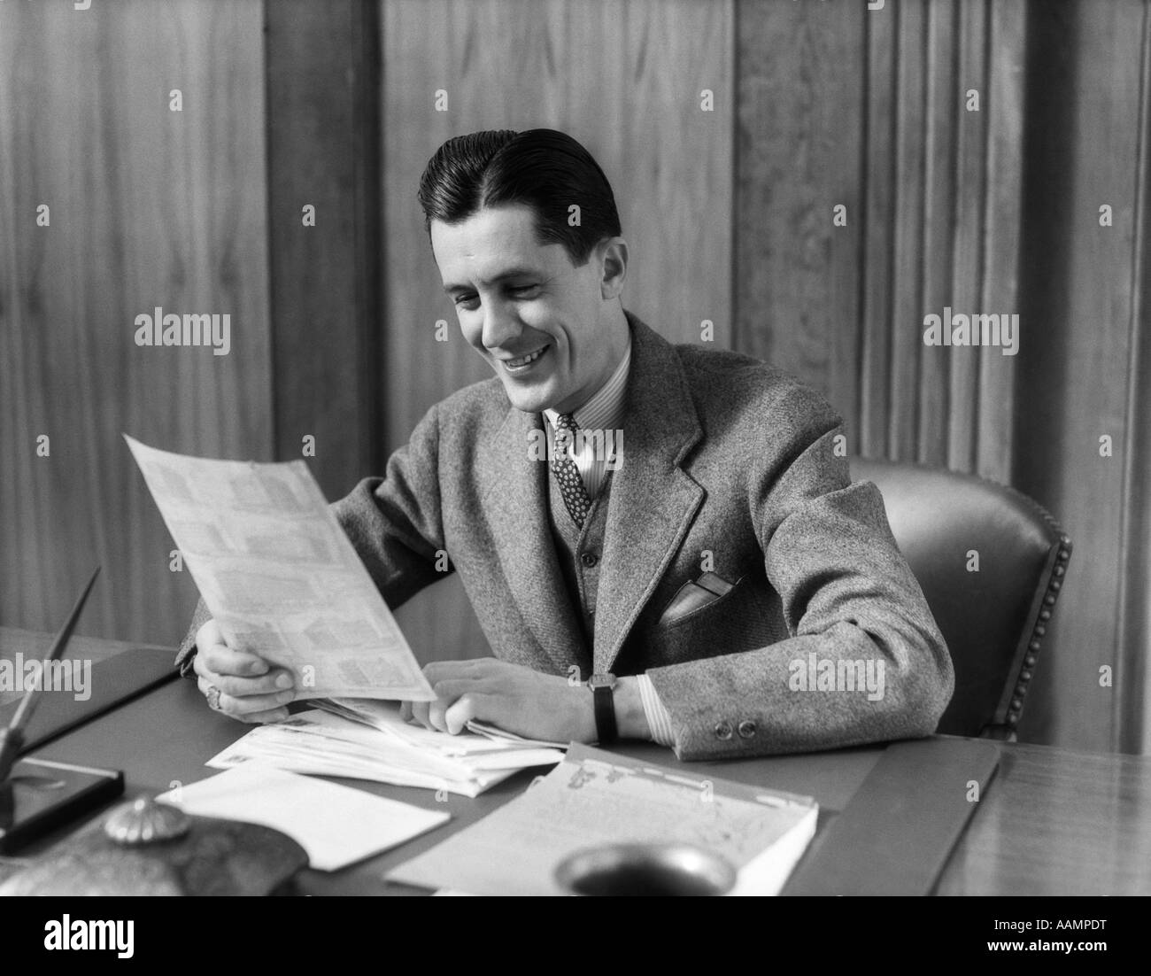 Happy man sitting at desk Black and White Stock Photos & Images - Alamy