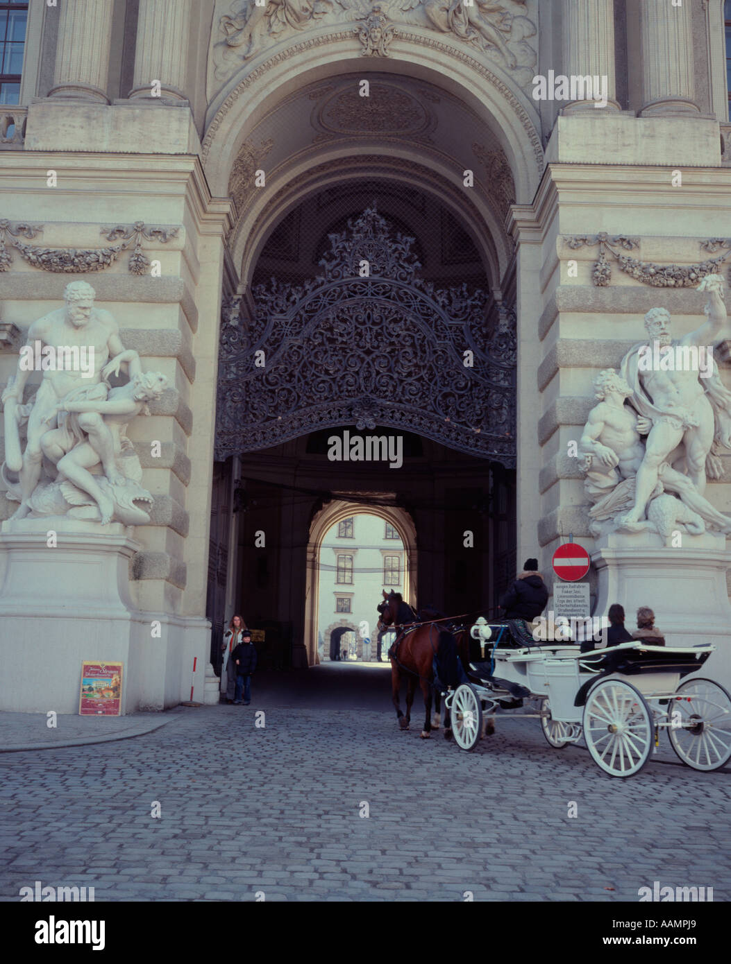 Traditional horse and carriage going through the elaborate gateway to ...