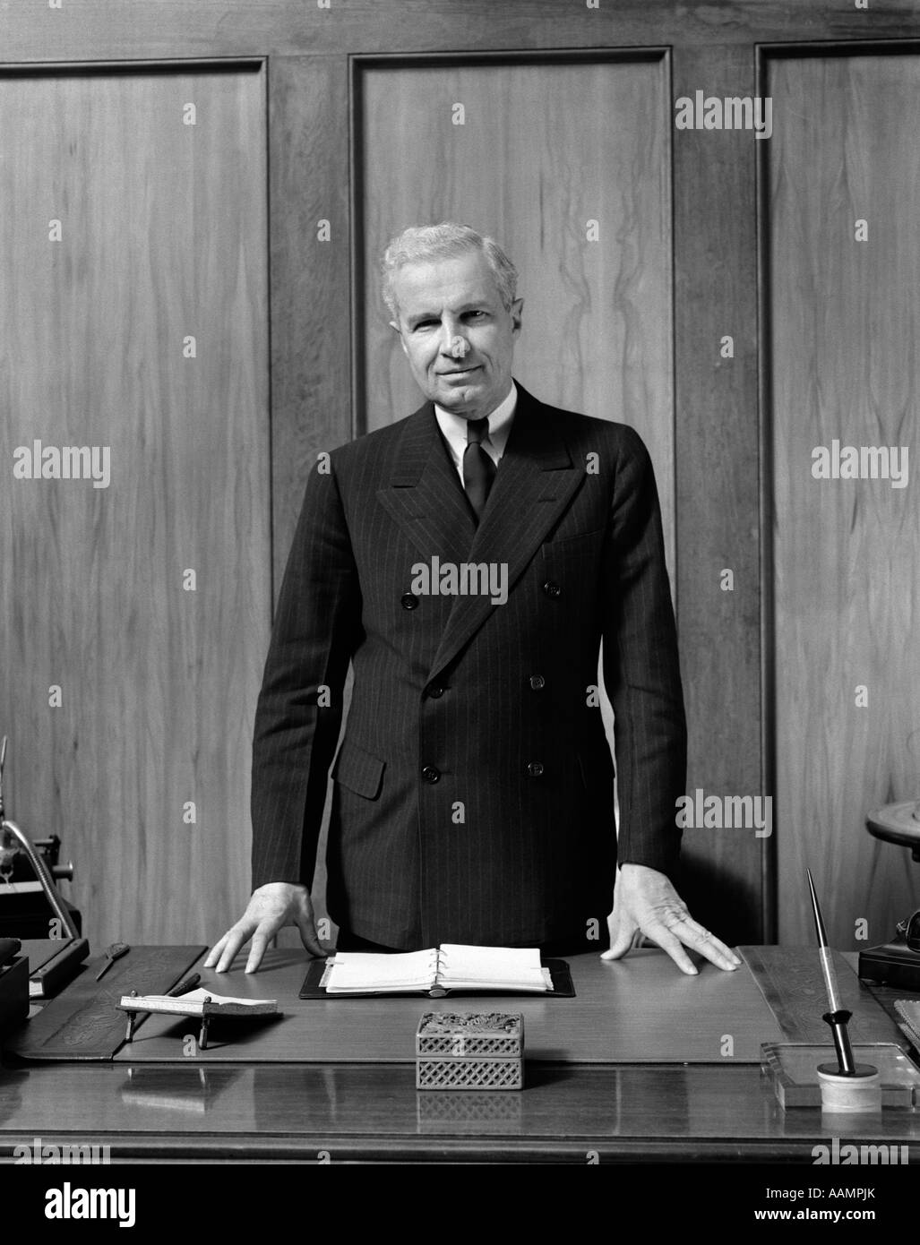 Man standing at office desk Black and White Stock Photos & Images - Alamy