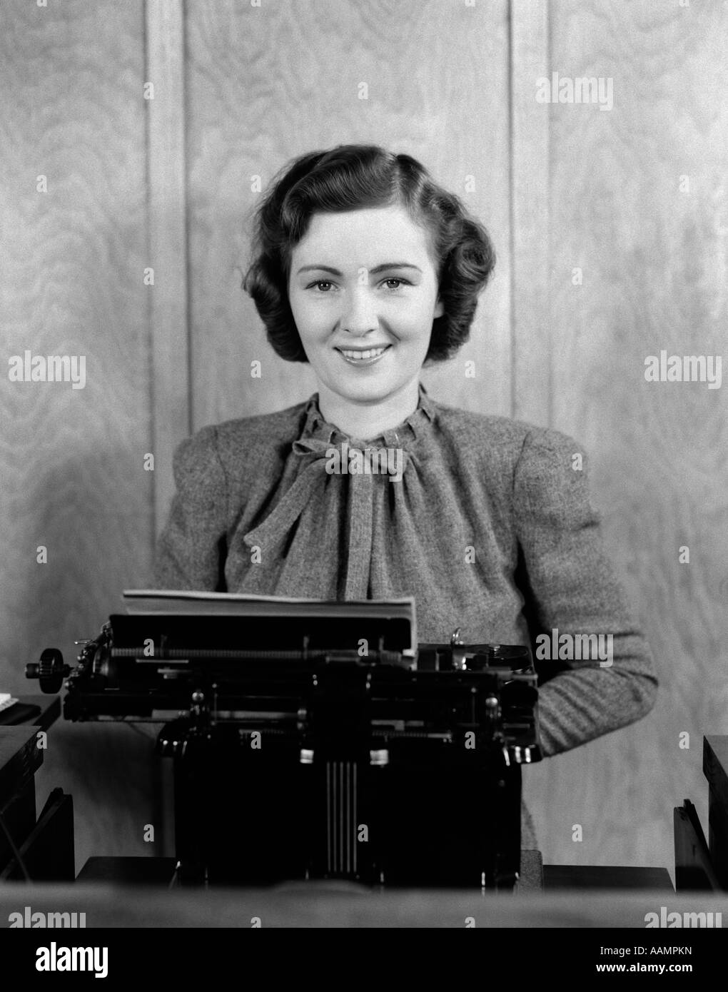 1940s SMILING YOUNG WOMAN SECRETARY TYPIST SITTING BEHIND OFFICE ...