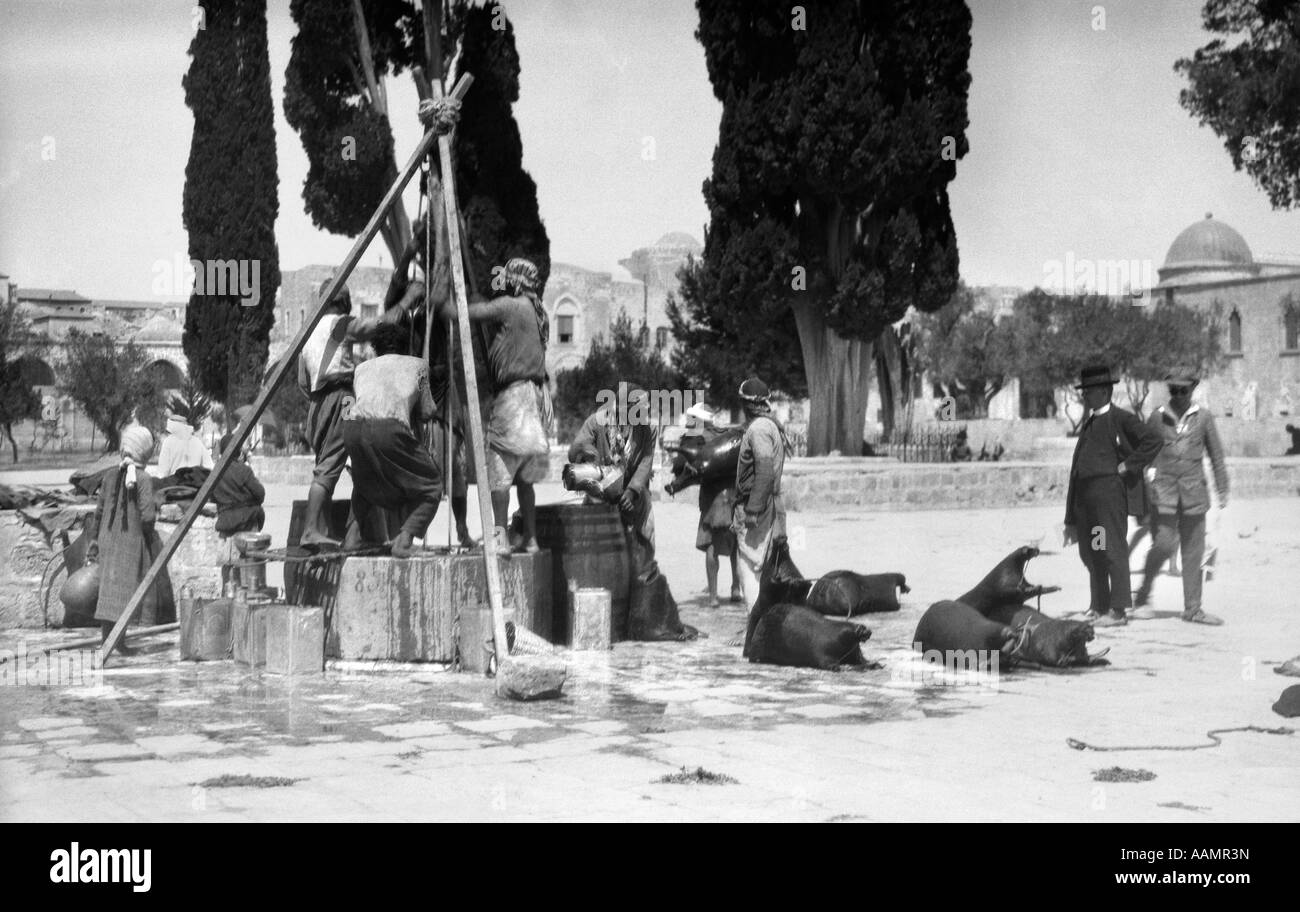 1920s 1930s LOCALS FILLING GOAT SKINS WITH WATER AT WELL IN PALESTINE ...