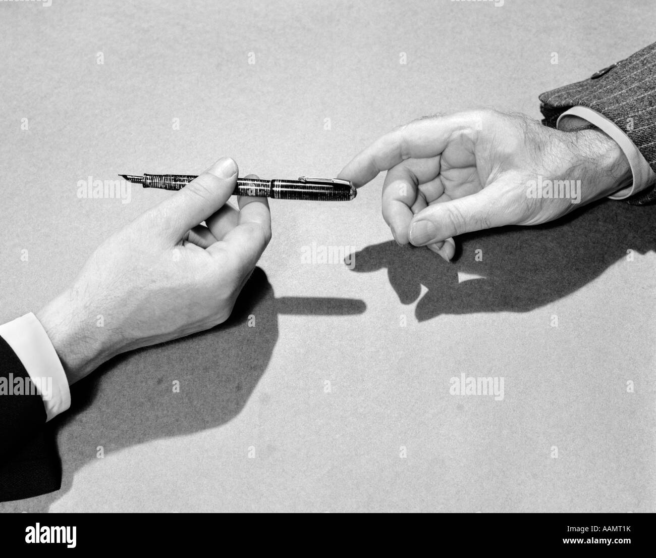 1940s FOUNTAIN PEN BEING PASSED FROM ONE BUSINESSMAN'S HAND TO ANOTHER ...