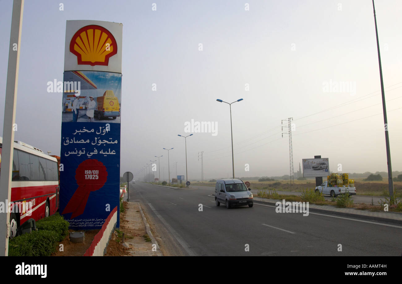 cars going past shell garage sign on highway service station outside ...