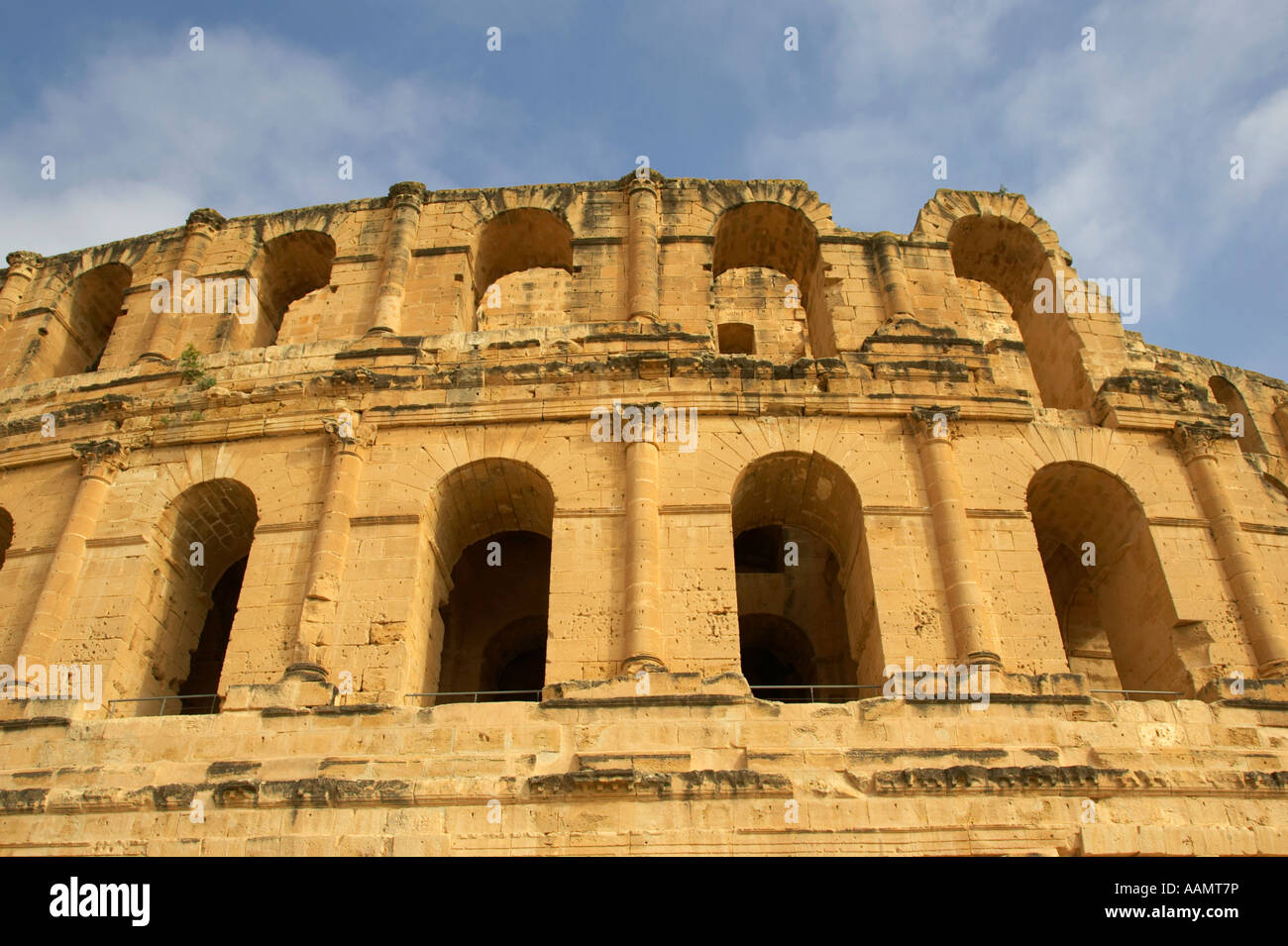 close up of the upper section of the old roman colloseum against blue ...