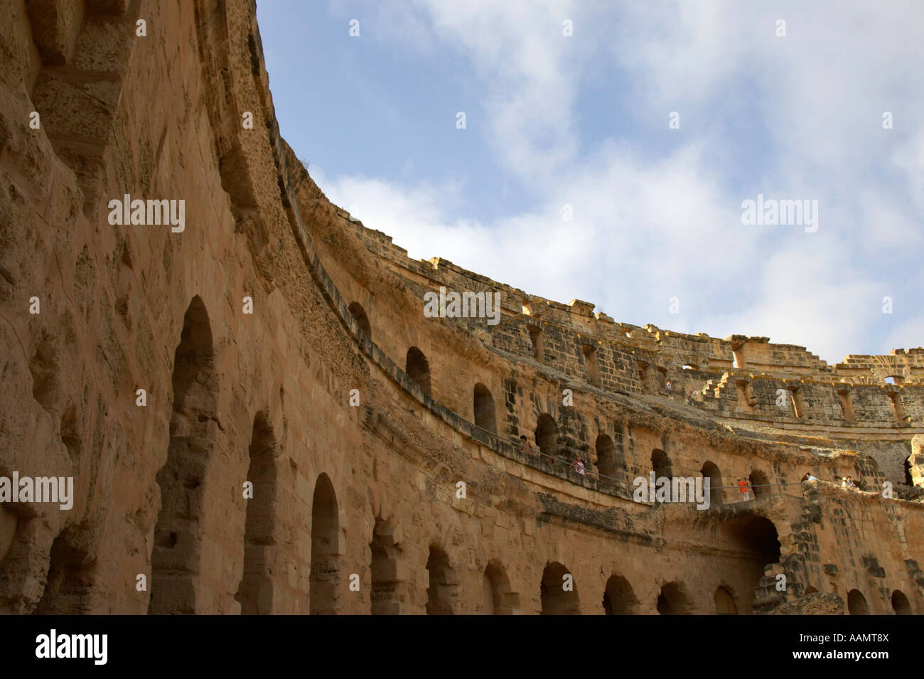 looking up at blue cloudy sky and upper tiers of the old roman ...