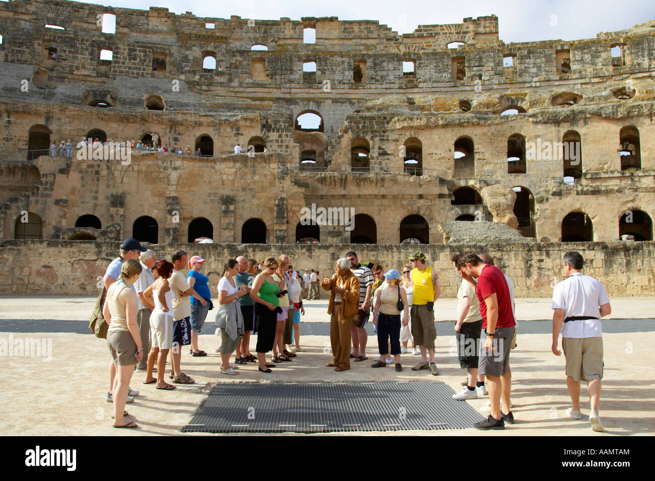 tour guide explains to group of british tourists about gladiator pits ...