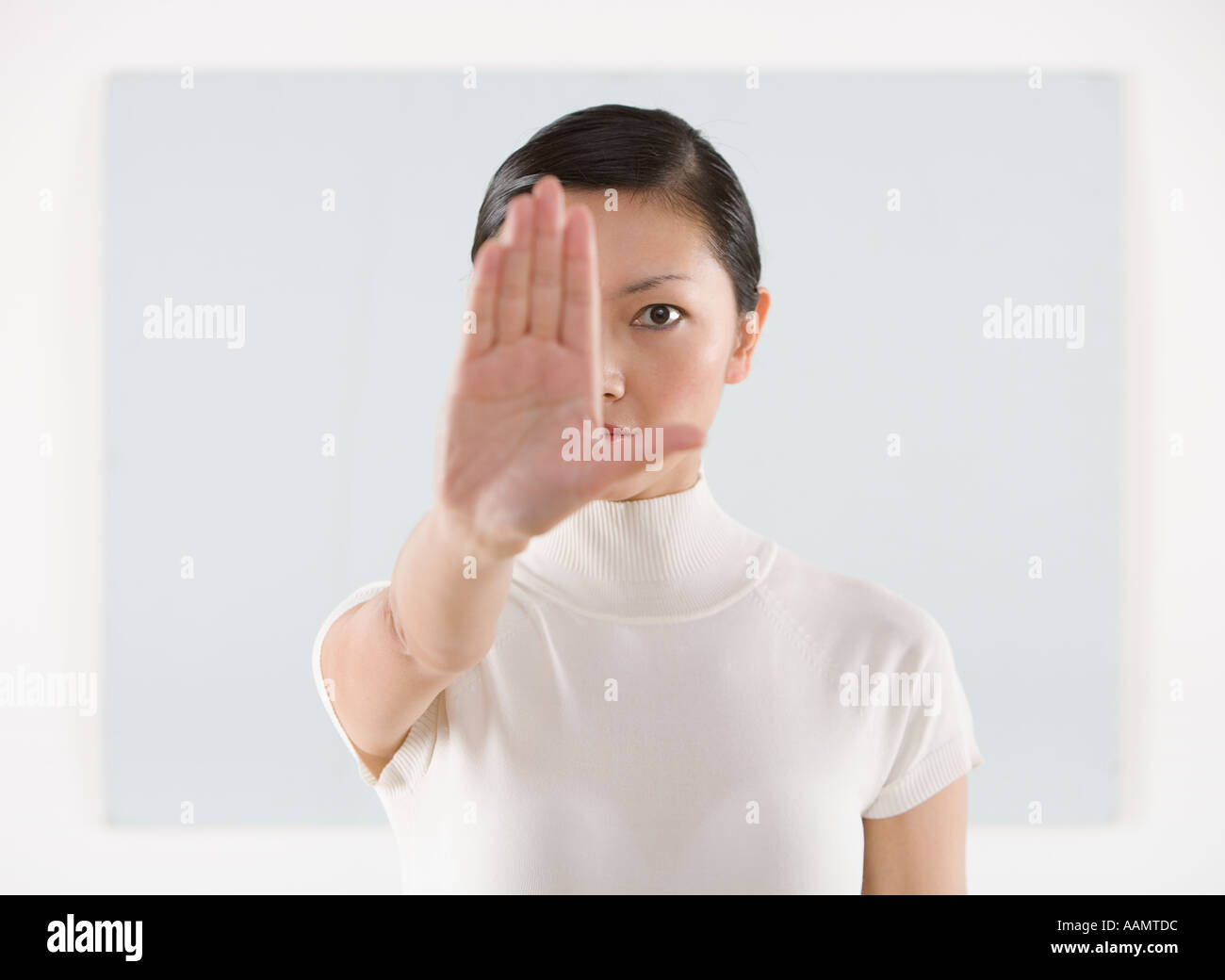 Portrait of woman with hand in front of face Stock Photo - Alamy
