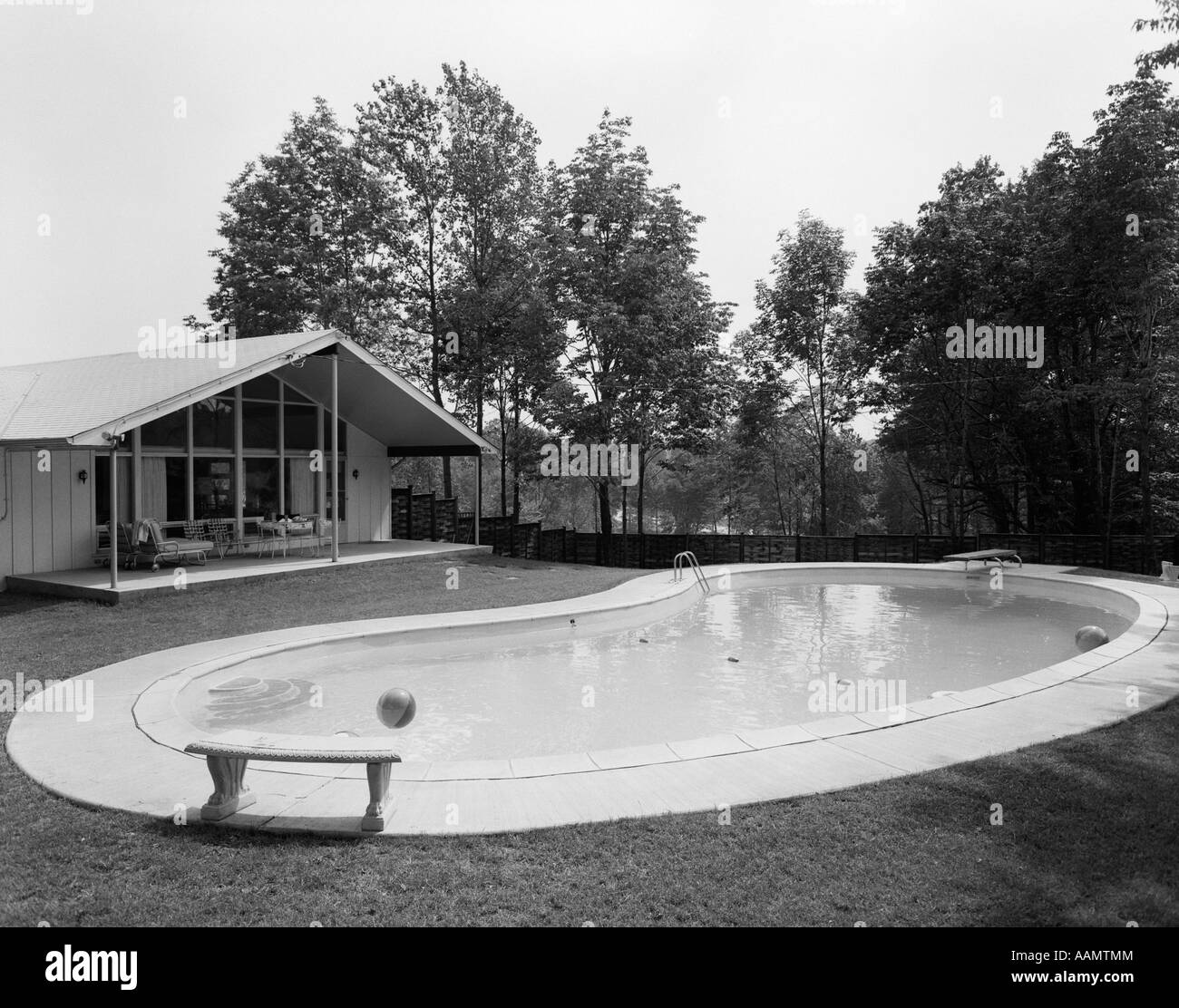 1960s KIDNEY-SHAPED POOL WITH BEACH BALLS FLOATING IN IT BEHIND RANCH ...
