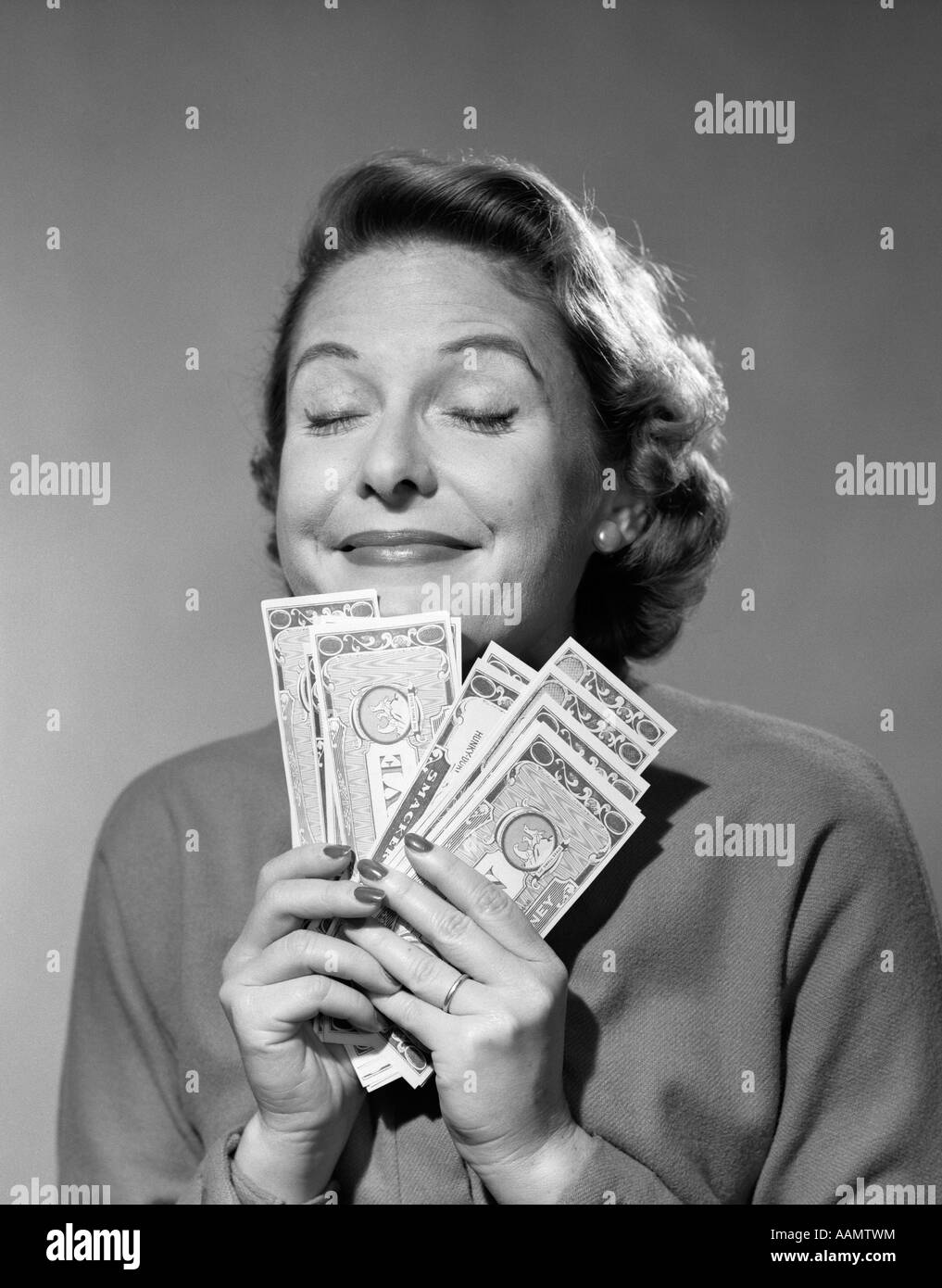 1950s PORTRAIT OF WOMAN SMILING WITH EYES CLOSED HOLDING MONEY Stock ...